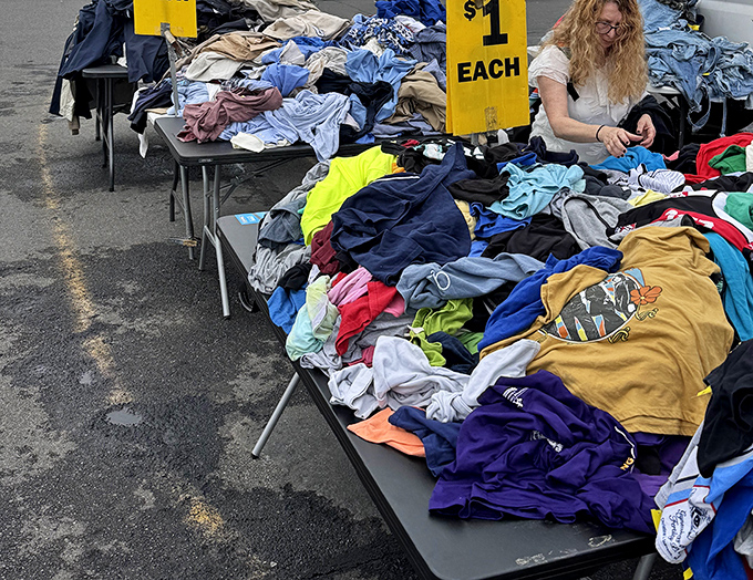The dollar clothing table&mdash;where dedicated diggers plunge elbow-deep into fabric mountains, hunting for that hidden designer gem.