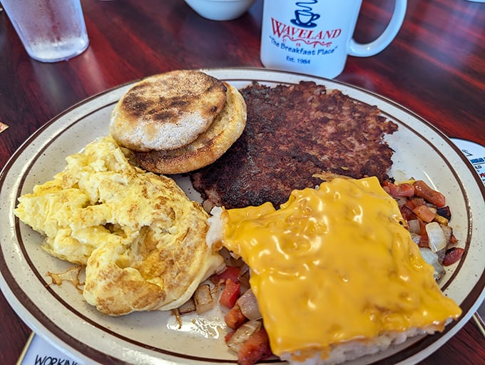 The breakfast plate that has it all&mdash;golden eggs, English muffin, crispy hashbrowns with melted cheese, and what appears to be corned beef hash. A complete morning symphony.
