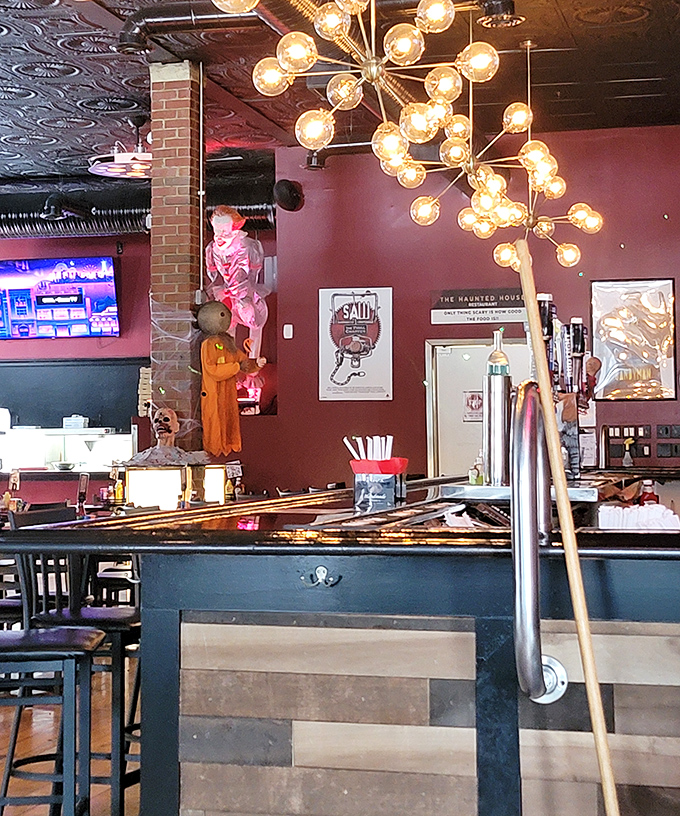 Modern chandeliers meet horror movie memorabilia in a space that feels like Tim Burton designed a really great restaurant.