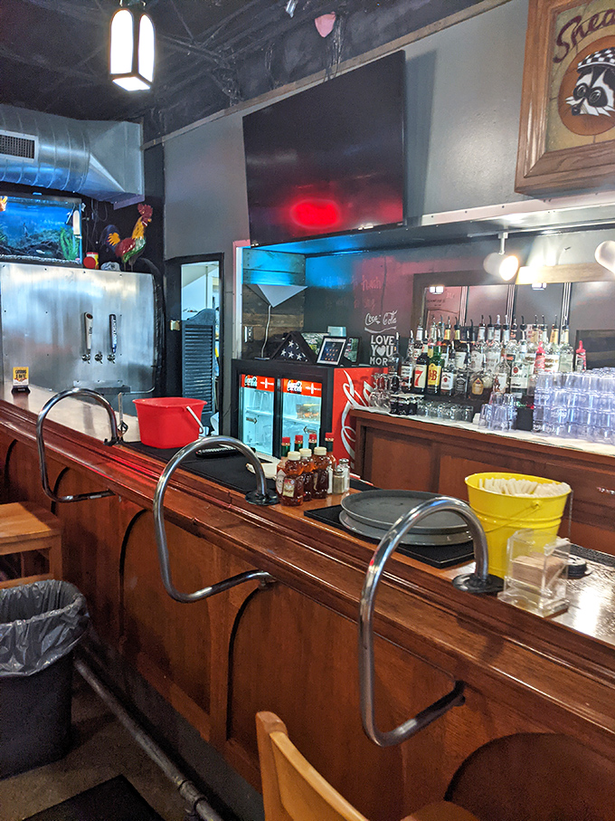 The bar counter stands ready for hungry patrons, a front-row seat to the culinary magic that's made Sneaky's a local legend.