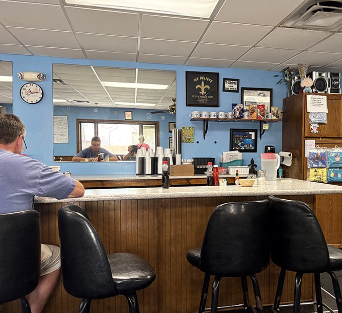 The counter where solo diners become regulars and coffee cups never stay empty.