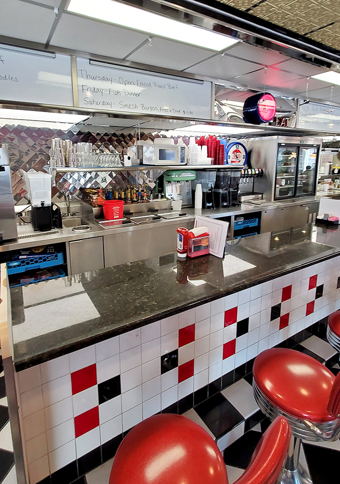 Red, white, and black—the holy trinity of diner design. This counter with its checkerboard pattern invites you to pull up a stool and order "the usual."