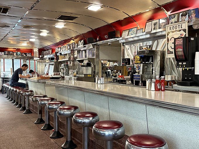The counter where regulars become family. Chrome stools await hungry travelers while the grill sizzles with promises of good things to come.