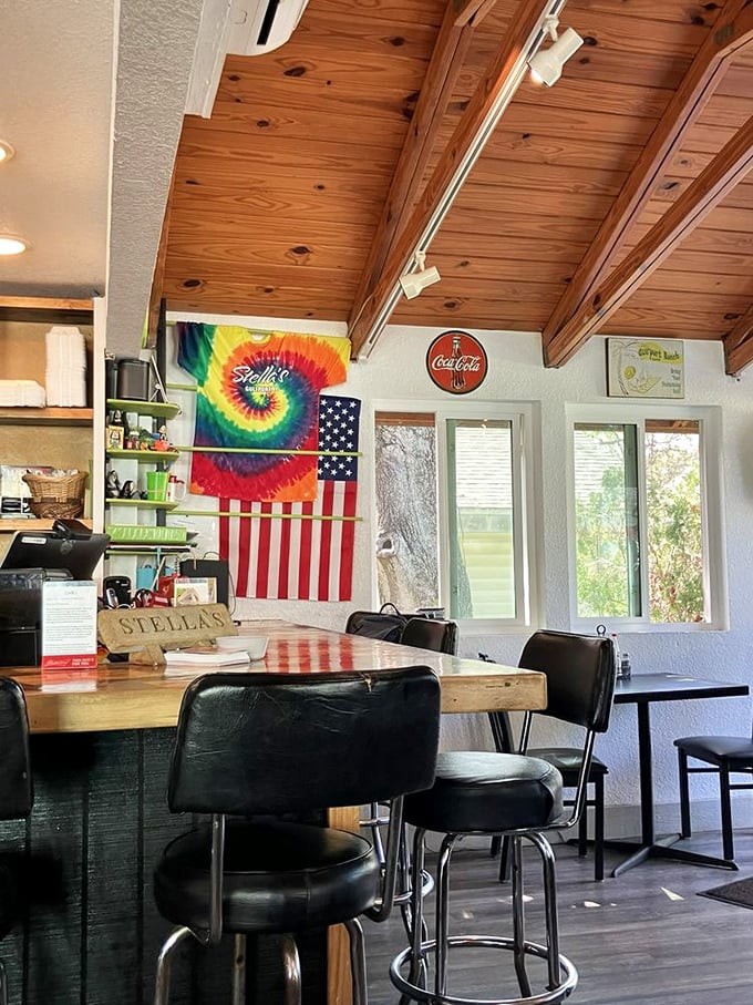 Wooden ceiling beams, tie-dye flags, and counter seating create that perfect "come as you are" vibe where breakfast tastes better and conversations flow easier.