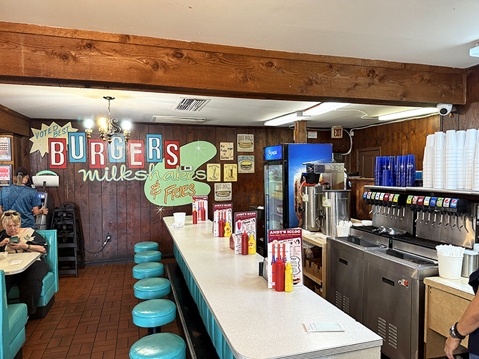The counter seating area&mdash;where solo diners become regulars, milkshake machines hum their soothing song, and "BURGERS" signs state the obvious deliciously.