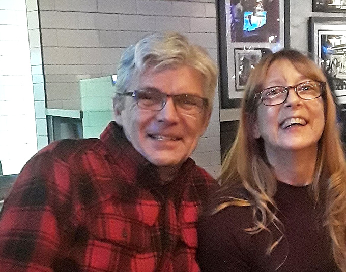 The dining area features warm wood tones and brick accents that create the perfect backdrop for both casual weeknight dinners and special celebrations.