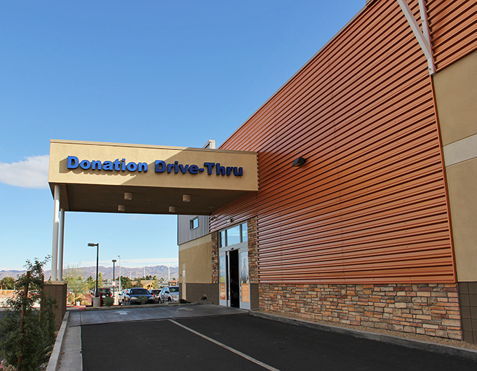 A drive-through donation center because apparently Henderson understands that charitable giving should be as convenient as fast food ordering.
