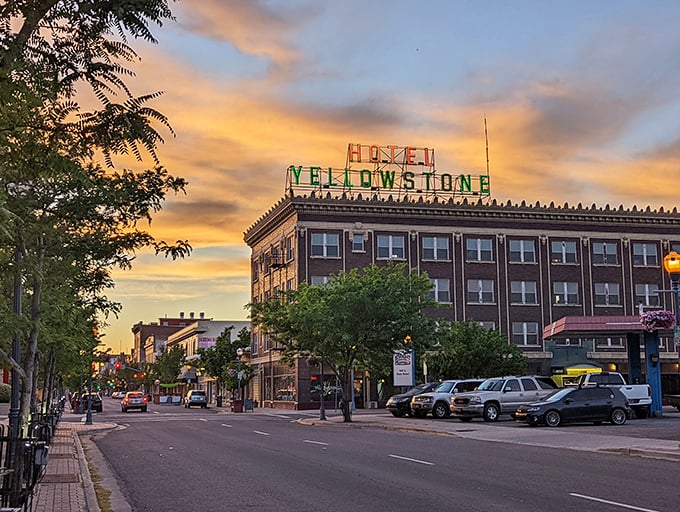 The historic Yellowstone Hotel anchors downtown as sunset paints the sky, promising evenings of affordable dining and entertainment just steps away.