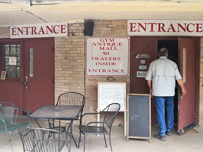 "GYM ANTIQUE MALL - 50 DEALERS INSIDE" promises an education in antiquing as shoppers enter through the original school doors.