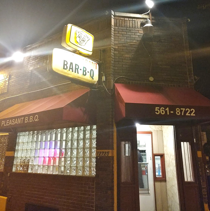 The nighttime glow of MT Pleasant's sign serves as a beacon for those seeking serious barbecue satisfaction after dark.