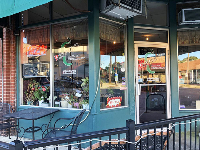 Neon signs glow with the promise of pizza and pasta behind glass. This storefront has likely witnessed countless first dates, celebrations, and regular Tuesday night dinners.