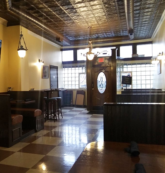 The exit view offers one last glimpse of that gorgeous checkerboard floor and tin ceiling. The perfect backdrop for mentally replaying your meal on the drive home.