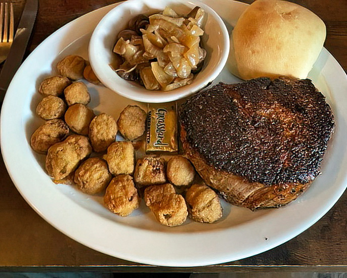 A perfectly cooked steak surrounded by sides that refuse to be overshadowed. That roll isn't just bread&mdash;it's the perfect tool for soaking up every last drop of flavor.