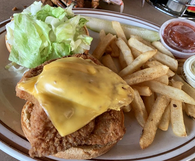 A perfectly fried fish sandwich that would make Poseidon himself jealous. That golden cheese melting over the top is pure sandwich architecture.
