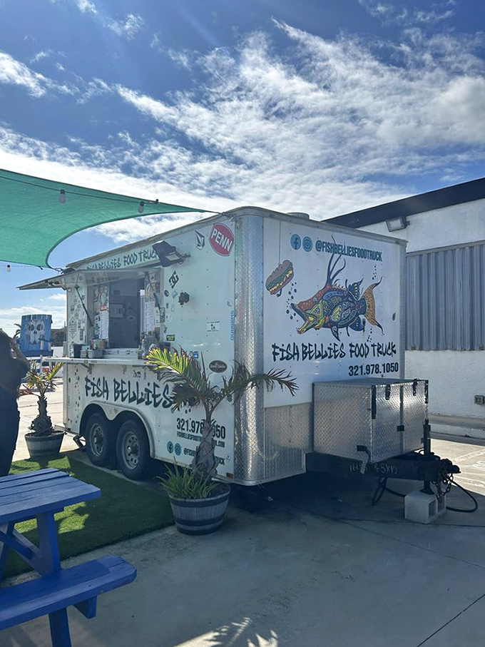 The Fish Bellies food truck in all its glory. A colorful mural of a fish hints at the treasures within this mobile seafood sanctuary.