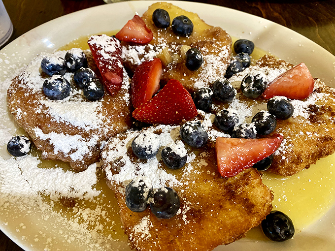 French toast that's dressed for success with fresh berries, powdered sugar, and enough visual appeal to make your Instagram followers genuinely jealous.