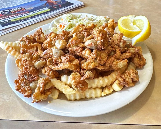 The ocean meets the fryer in perfect harmony&mdash;golden-battered clams and crinkle-cut fries create a New England classic that never disappoints.