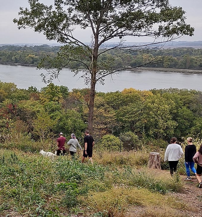 Hikers follow nature's invitation down to the riverbank, where the view rewards every step taken on the winding trail.