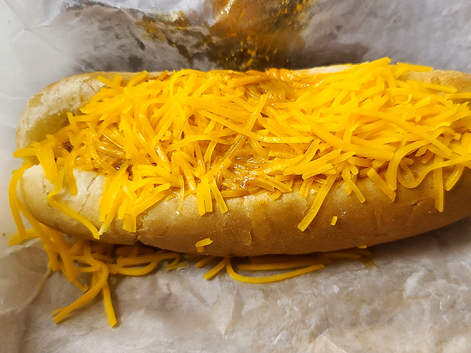 This isn't just a hot dog &ndash; it's a cheese-covered celebration that requires both hands, several napkins, and absolutely zero regrets.