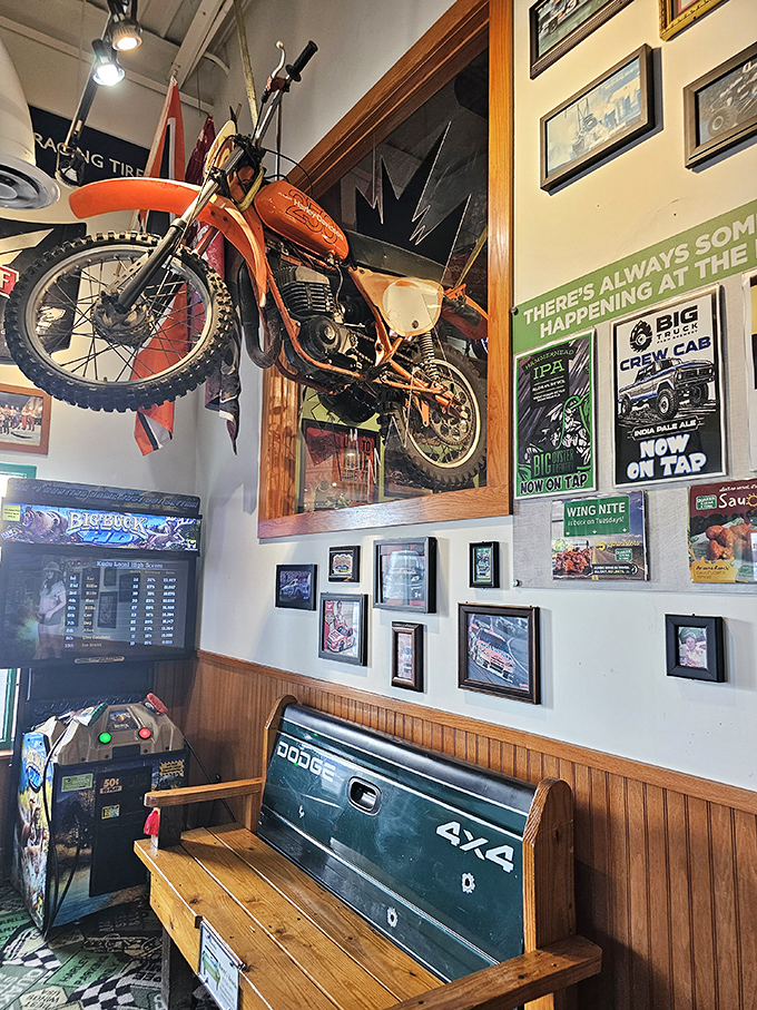 That's not just a motorcycle on the wall—it's a conversation starter hanging above a bench made from a Dodge truck tailgate. Automotive upcycling at its finest.