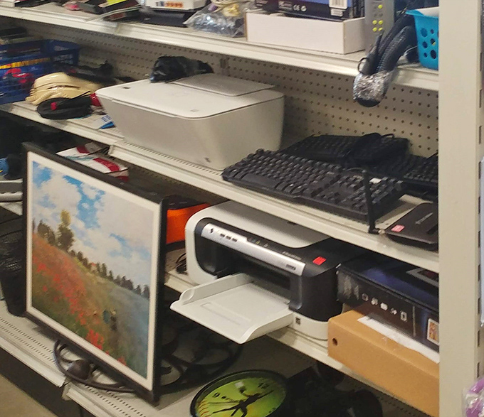 The tech corner: where printers, keyboards, and forgotten art prints create an eclectic time capsule of the digital revolution's ongoing evolution.