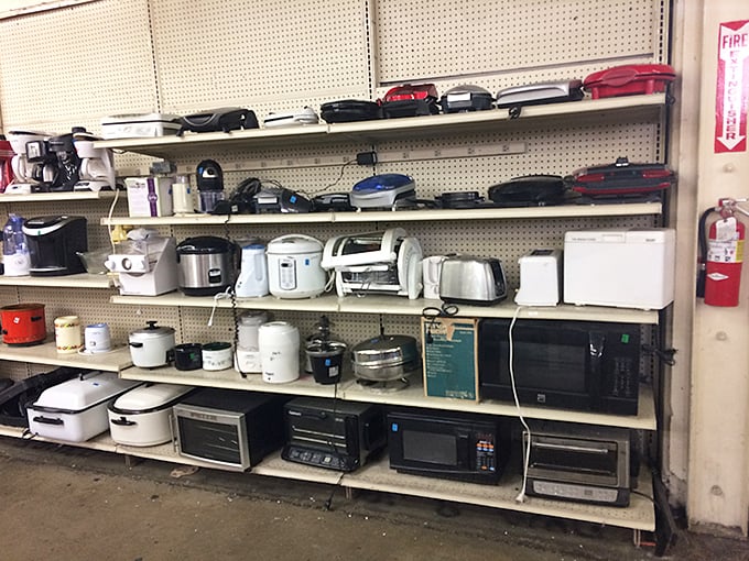 The small appliance graveyard, where rice cookers and toaster ovens await resurrection. That white microwave has reheated a thousand leftovers.