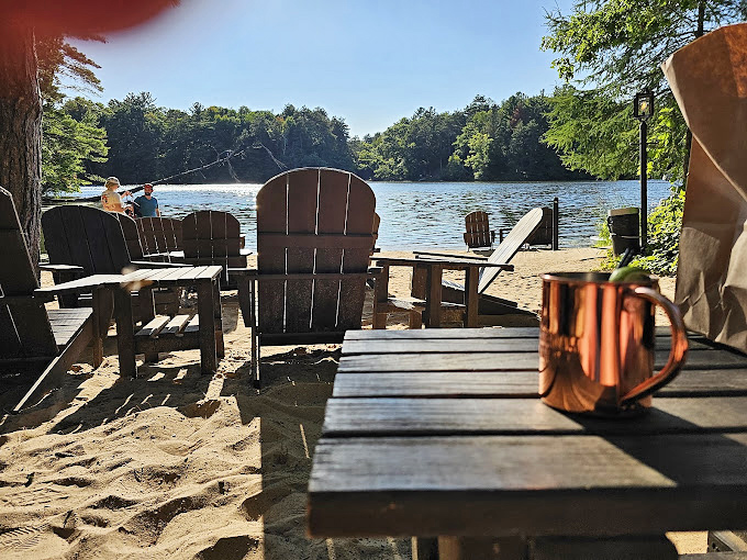 The lakeside seating area &ndash; where copper mugs meet golden hour, and you realize some Wisconsin moments are too perfect to capture even in photographs.