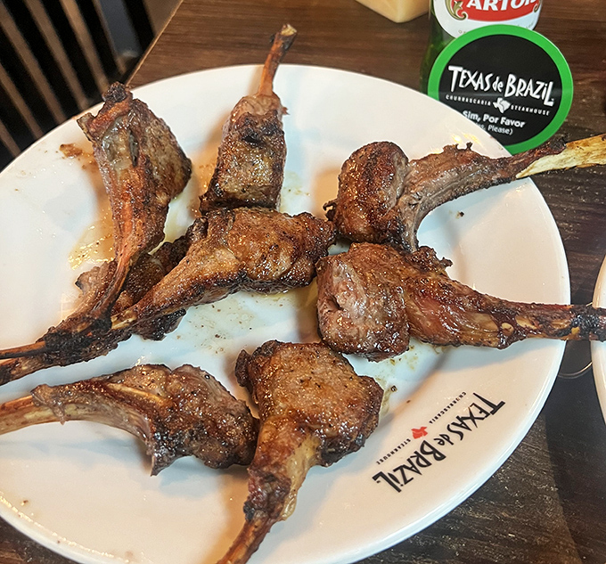 Lamb chops arranged like meaty flower petals on fine china. The kind of dish that makes vegetarians question their life choices.