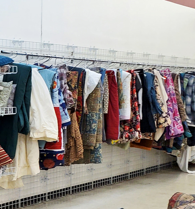 Vintage linens and unique textiles hang like colorful flags of thrifting victory. Each piece whispers stories of dinner parties past while promising new memories to come.