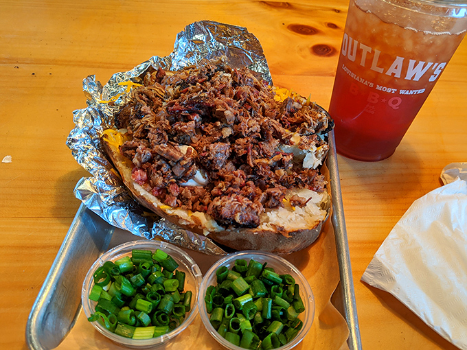 The loaded baked potato – where a humble spud becomes the foundation for a mountain of barbecue excellence.