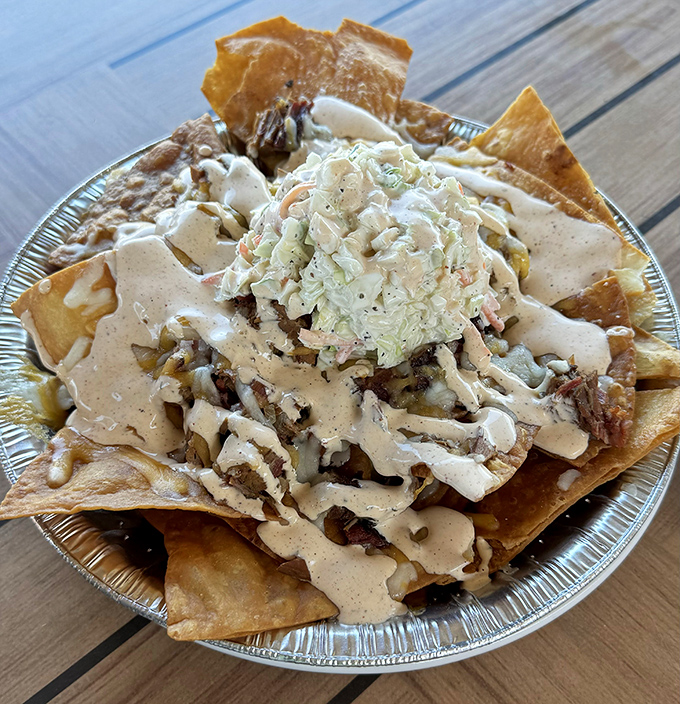 BBQ nachos that break all the rules in the best possible way&mdash;crispy tortilla chips loaded with smoky pulled pork, creamy sauce, and tangy slaw for the ultimate indulgence.