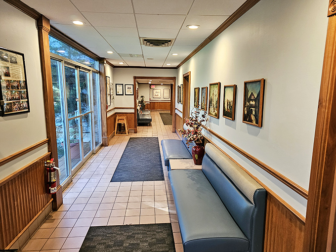 The entryway gallery wall tells stories of decades past, while the blue bench awaits those wise enough to arrive early.