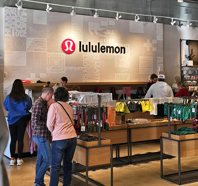 Lululemon's minimalist aesthetic draws in shoppers seeking athleisure enlightenment. Where yoga pants transcend exercise to become a lifestyle choice worth waiting in line for.