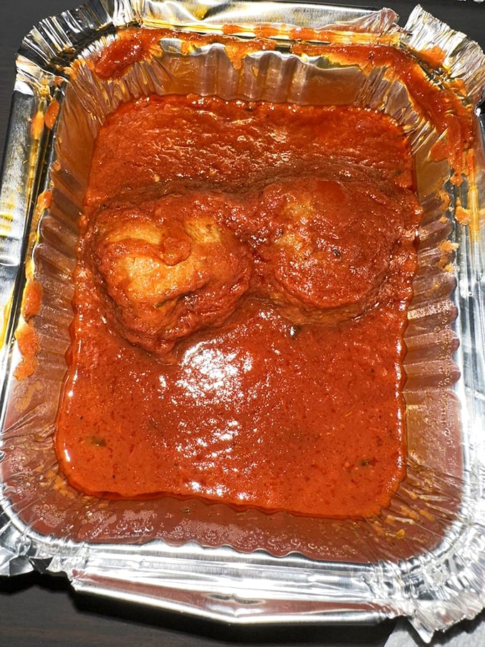 Meatballs swimming in sauce, ready for takeout that'll make your kitchen smell like an Italian restaurant.