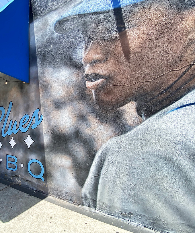 This striking mural outside Baby Blues BBQ isn't just decoration &ndash; it's a soulful promise of the authentic Southern experience waiting inside.