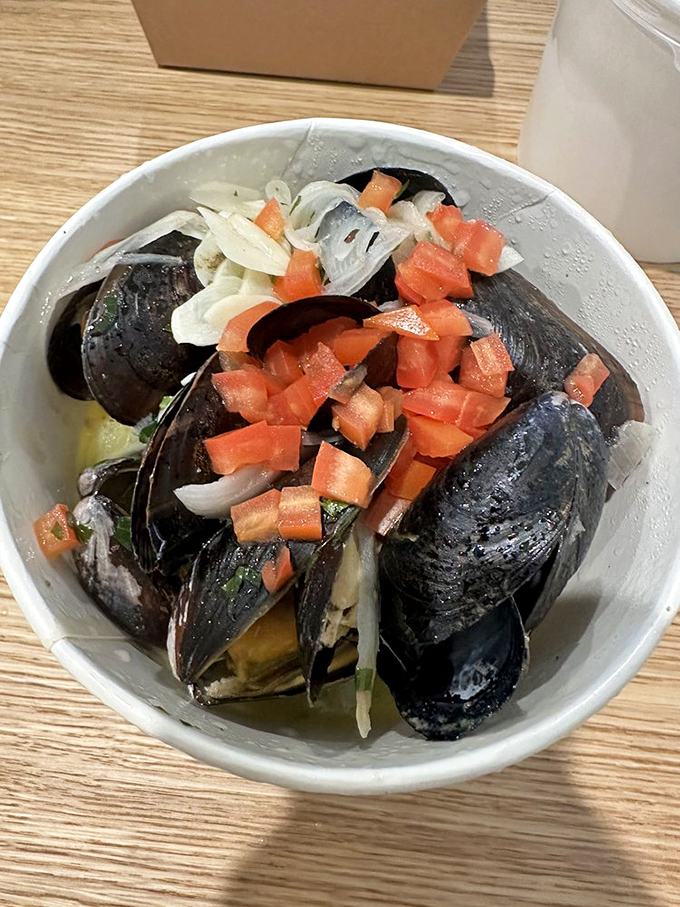 Mussels that have opened up to reveal their secrets, bathing in a broth worthy of bread-dipping reverence.