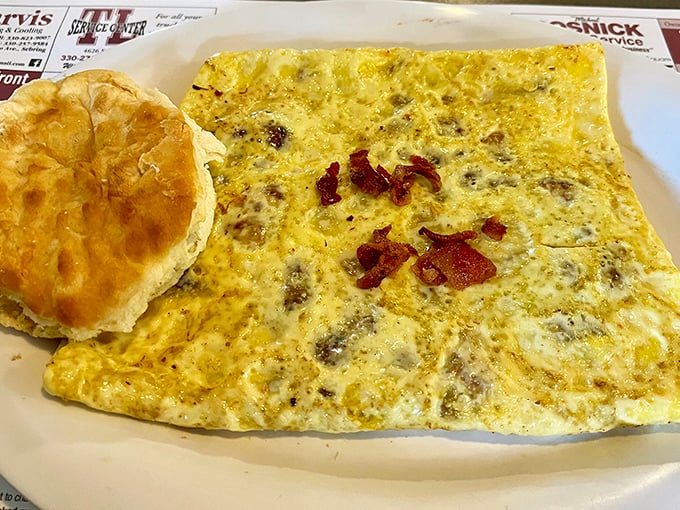 An omelet so perfectly executed it deserves its own cooking show. That biscuit on the side isn't just a sidekick &ndash; it's a co-star.
