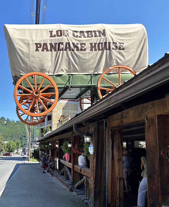 The line forms under the covered wagon sign, where patient breakfast pilgrims await their turn at the temple of flapjacks.