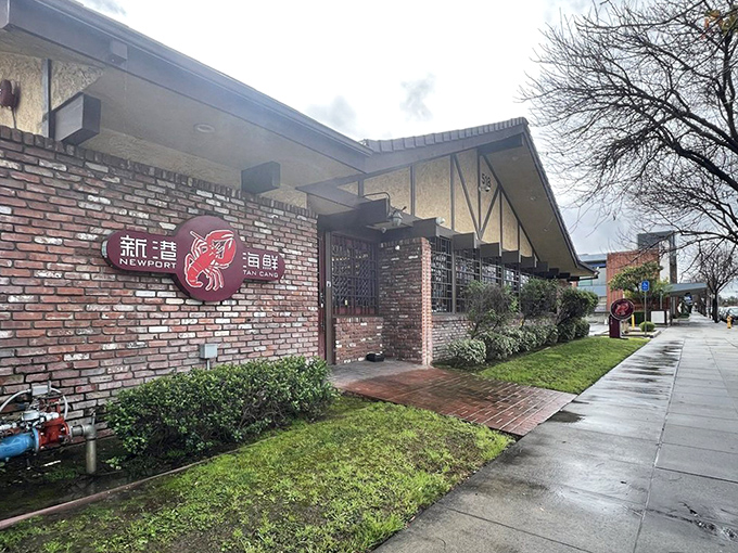 Even on rainy days, Newport Seafood's brick exterior with its distinctive red sign promises warmth, comfort, and seafood that will make you forget about the weather entirely.