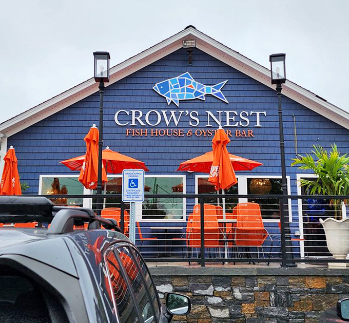 The iconic blue exterior with its mosaic fish sign &ndash; like a beacon guiding hungry travelers to their seafood salvation. Those orange chairs are ready for you.