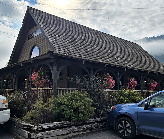 The porch where anticipation builds and satisfied patrons linger. Those hanging baskets aren't just decorative&mdash;they're nature's way of blessing this culinary sanctuary.