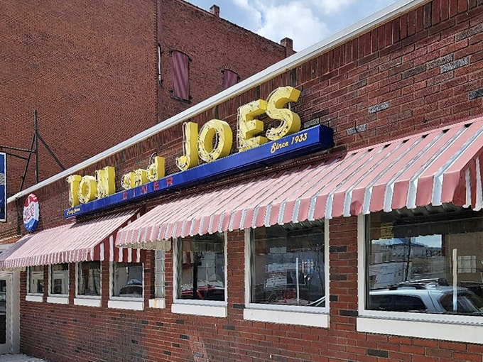 The exterior view that has welcomed generations of diners. Those red and white awnings aren't just decoration&mdash;they're a promise of consistency in a changing world.