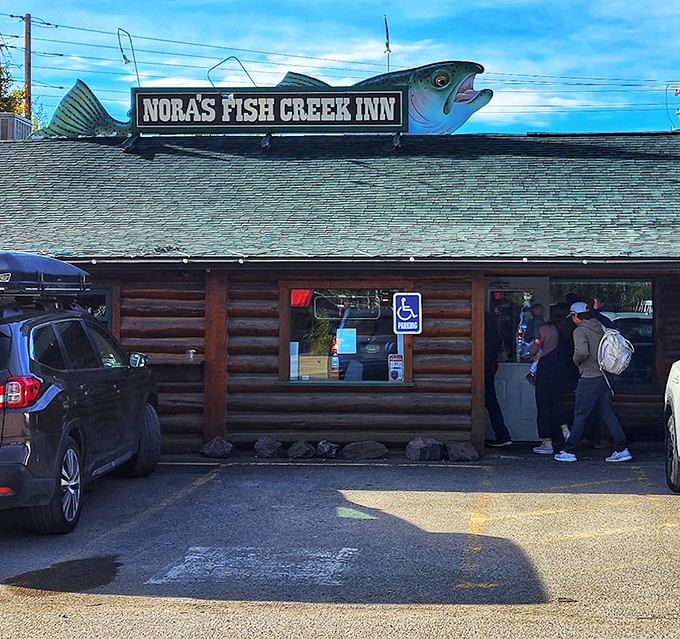 The iconic fish sign beckons hungry travelers like a beacon of breakfast hope. Those people walking in? They're about to have a very good day.