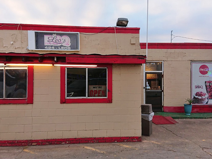 The weathered exterior with its bright red trim stands as a testament that great barbecue needs no fancy wrapping.