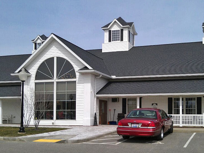 The classic white farmhouse architecture with its distinctive cupolas stands ready to welcome hungry travelers, regardless of whether they arrive by car or buggy.