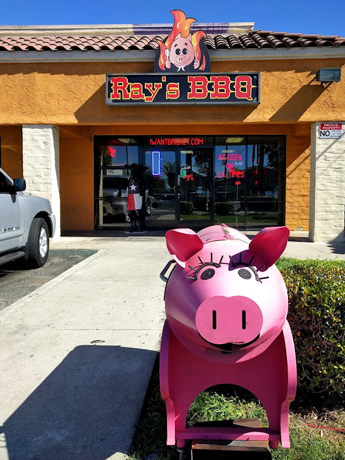 The pink pig guardian stands sentinel outside, a whimsical warning that serious meat business happens inside these walls.