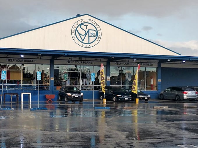 Even on rainy days, dedicated thrifters make their pilgrimage. The blue-trimmed building stands like a beacon for sustainable shopping in a disposable world.