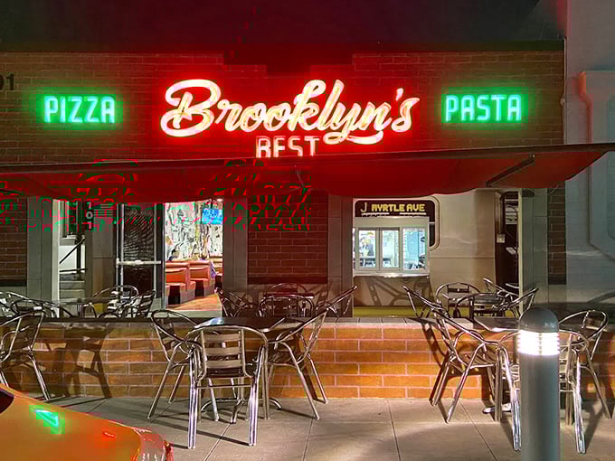 As night falls, the neon glow transforms the patio into an inviting oasis. Pizza tastes even better under the stars&mdash;it's a scientific fact.