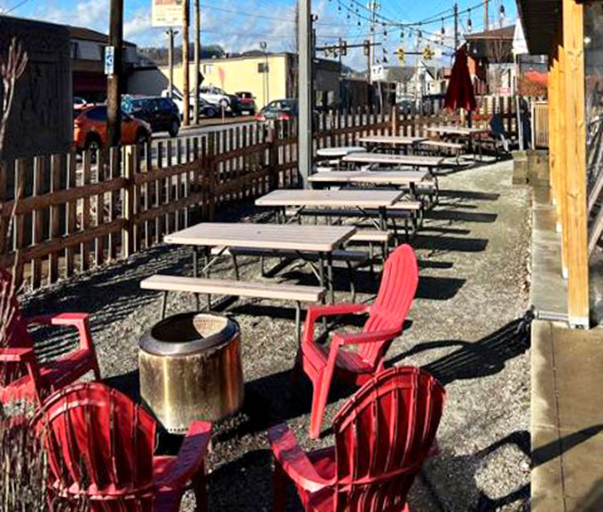 Picnic tables await beneath string lights, where the outdoor dining area transforms ordinary meals into barbecue memories worth making.
