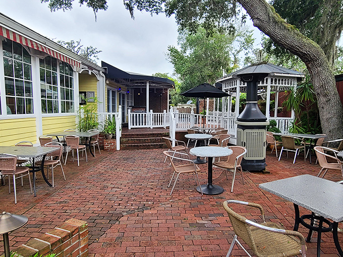 The brick courtyard offers al fresco dining under ancient oaks. Florida's weather and St. Augustine's charm create the perfect outdoor dining backdrop.